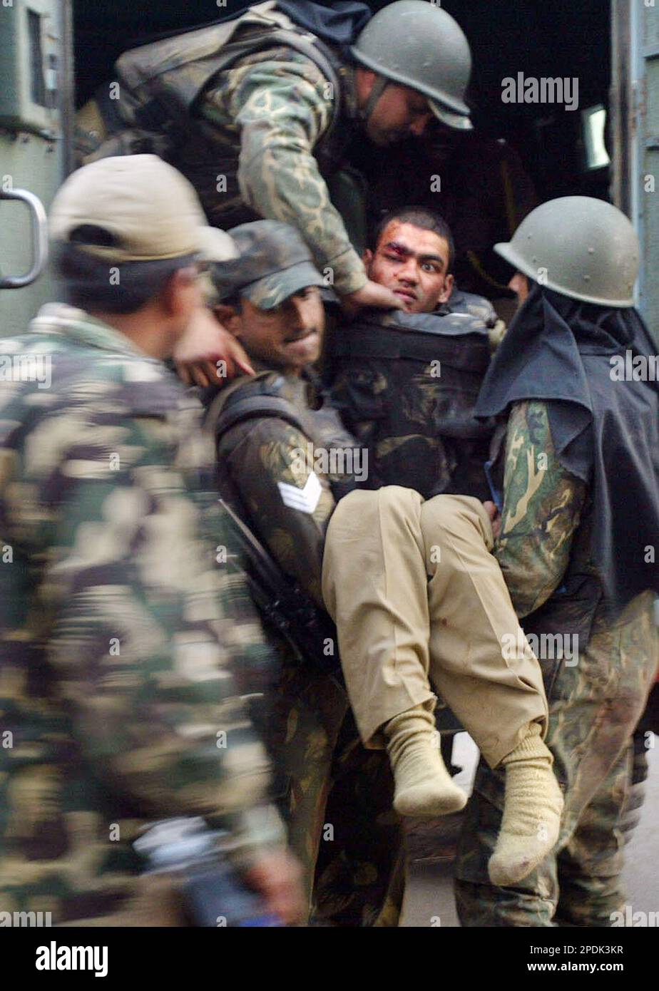 Indian soldiers help their colleague who was wounded after militants ...