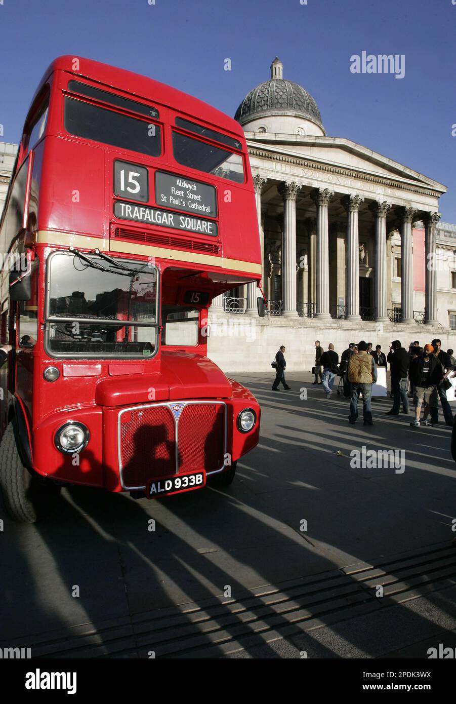 Shadows of people around two Routemaster London Buses parked in ...