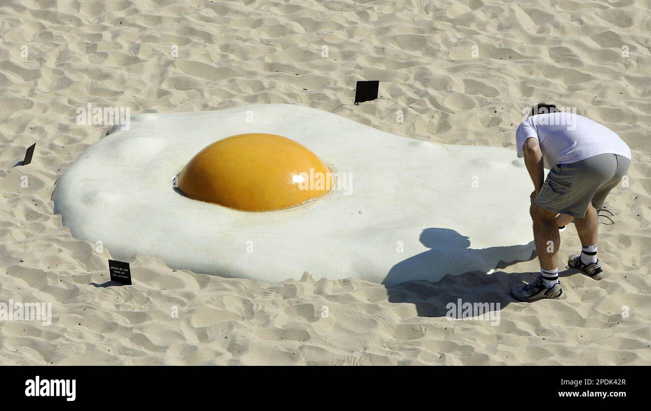 A man inspects an artwork called 'Big Chook', made of fibreglass and ...