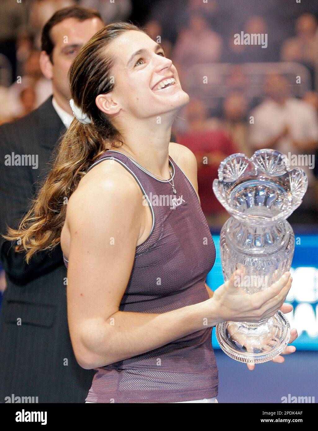 Amelie Mauresmo of France watches fireworks as she holds up the Billie ...