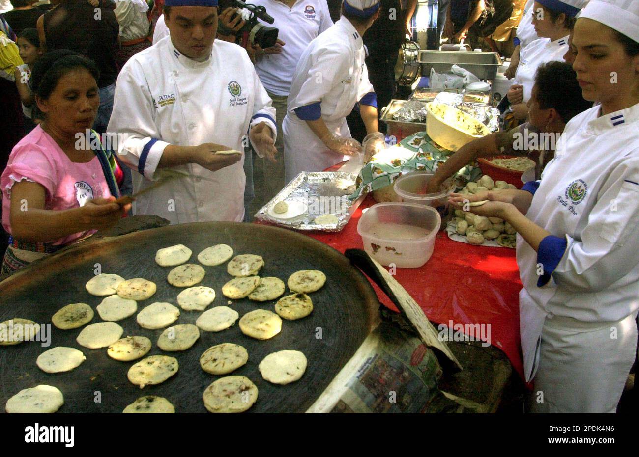 Cooks demonstrate the preparation of pupusas in Los Planes de Renderos ...