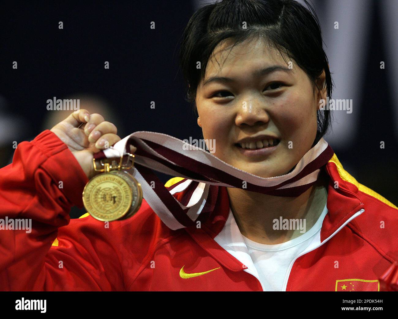 China's Chunhong Liu celebrates after she won the women's 75 kg event ...