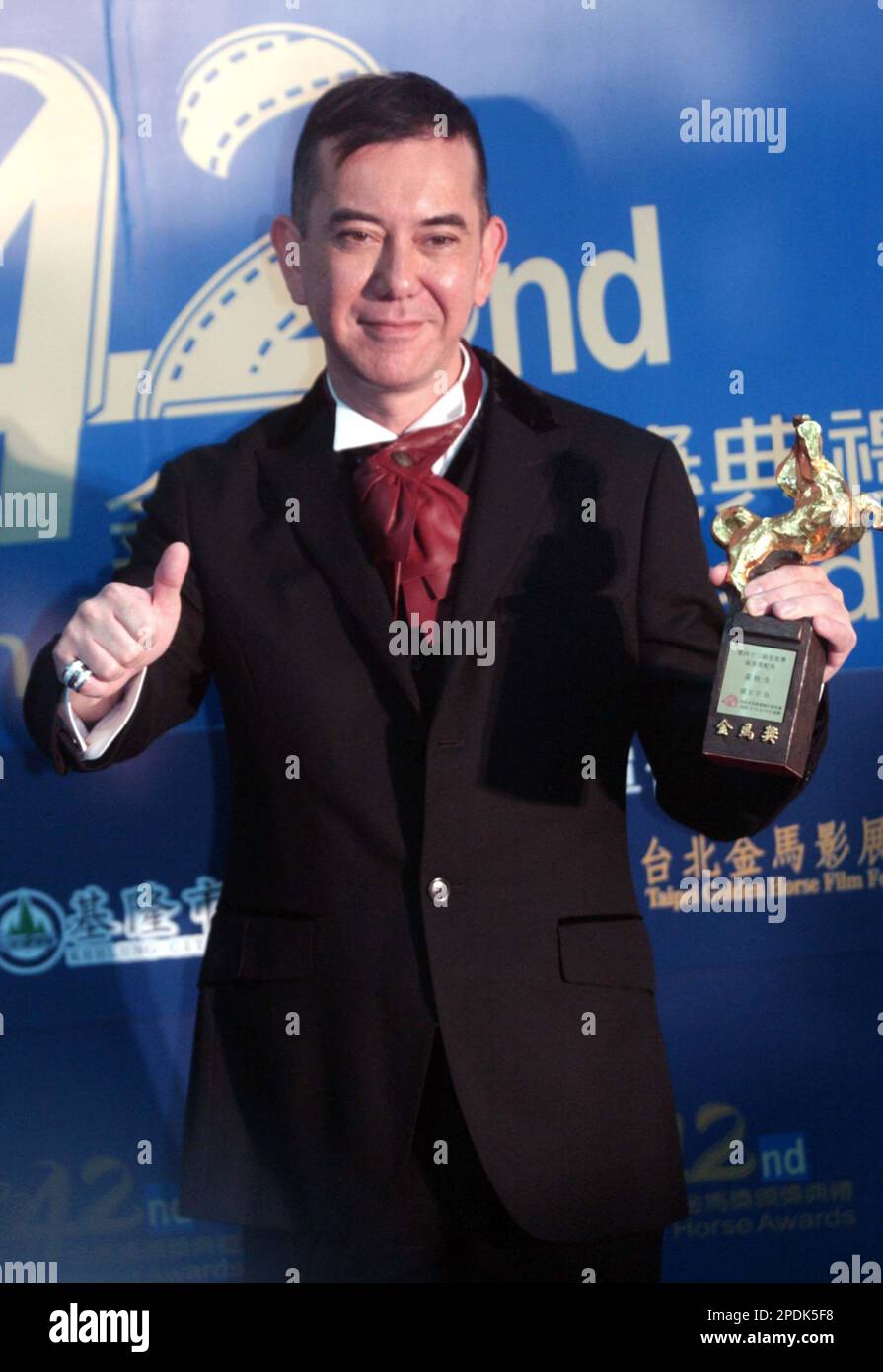 Hong Kong actor Anthony Wong holds his trophy smile after receiving the ...
