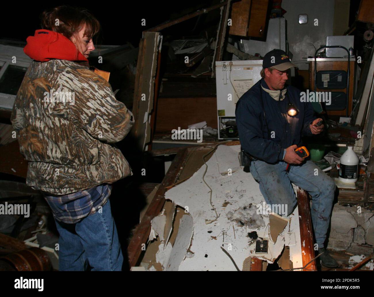 Brenda Bergman, left, and Dan Bergman, right, look for salvageable ...