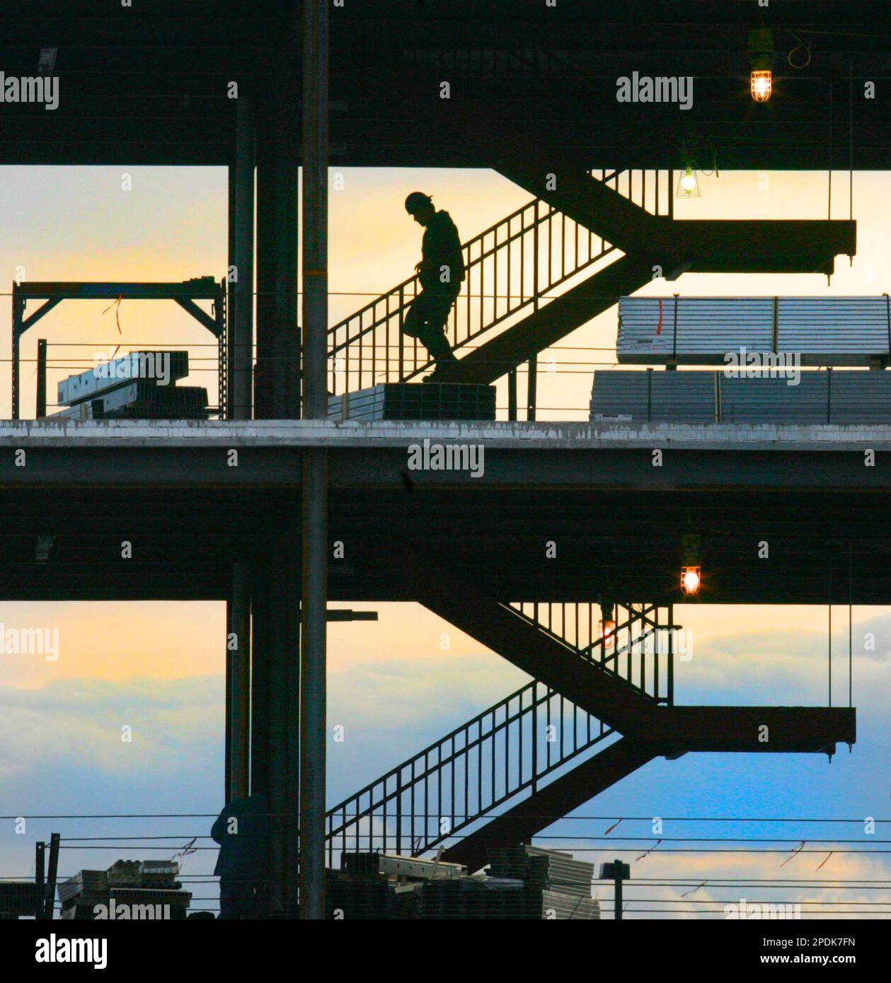 A construction worker walks down a flight of stairs in a new medical ...