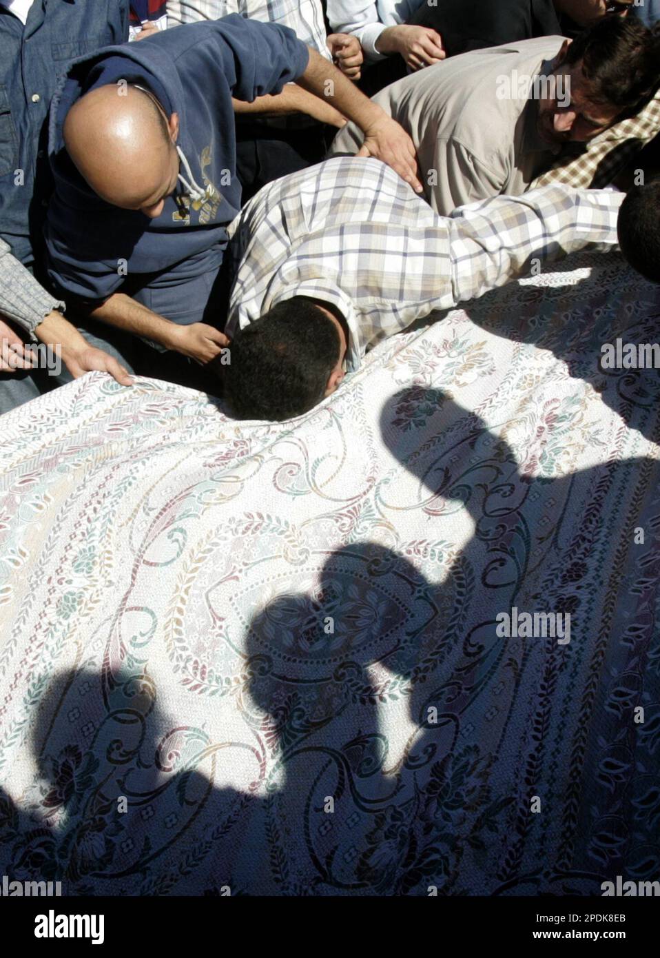 The son of Fathia Ayyash, centre, who was killed during the wedding ...