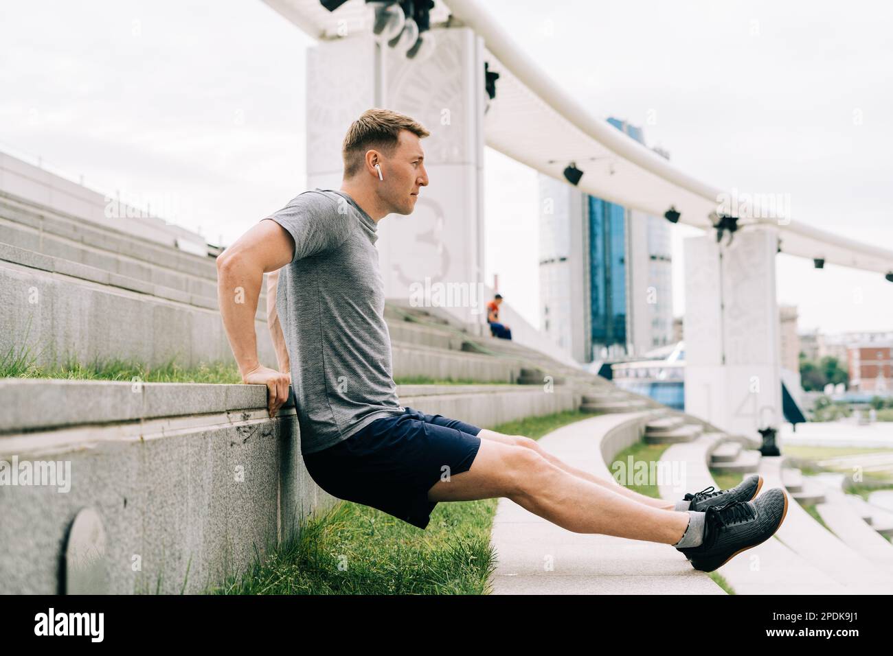 Young man has fitness workout. Male athlete does abs exercise, sport ...