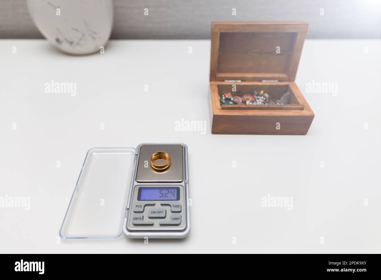 scales for small items are on the table. jewelry scale. golden ring ...