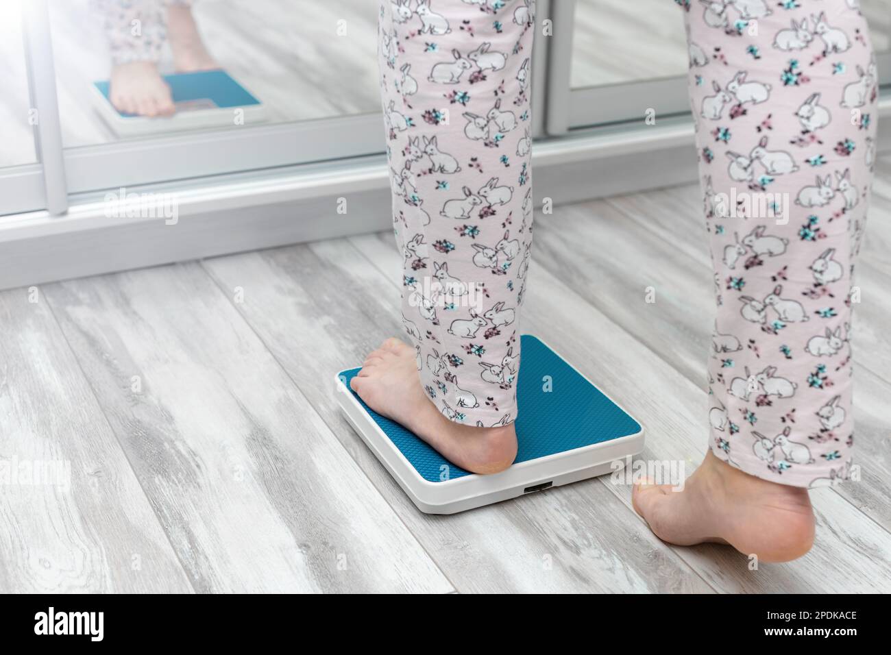 woman stepping on the scales to control her weight. weight loss and ...