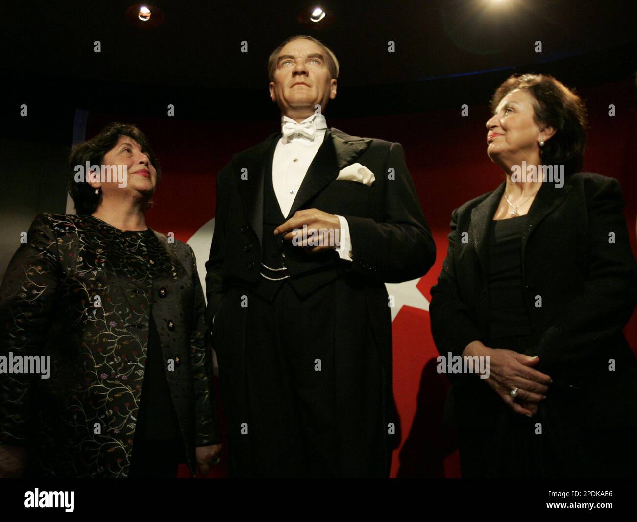 Turkish women pose for photographs with the newly-unveiled waxwork statue of Mustafa Kemal ...