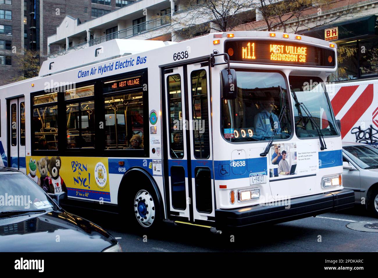 A New York City hybrid electric bus makes its way through traffic ...