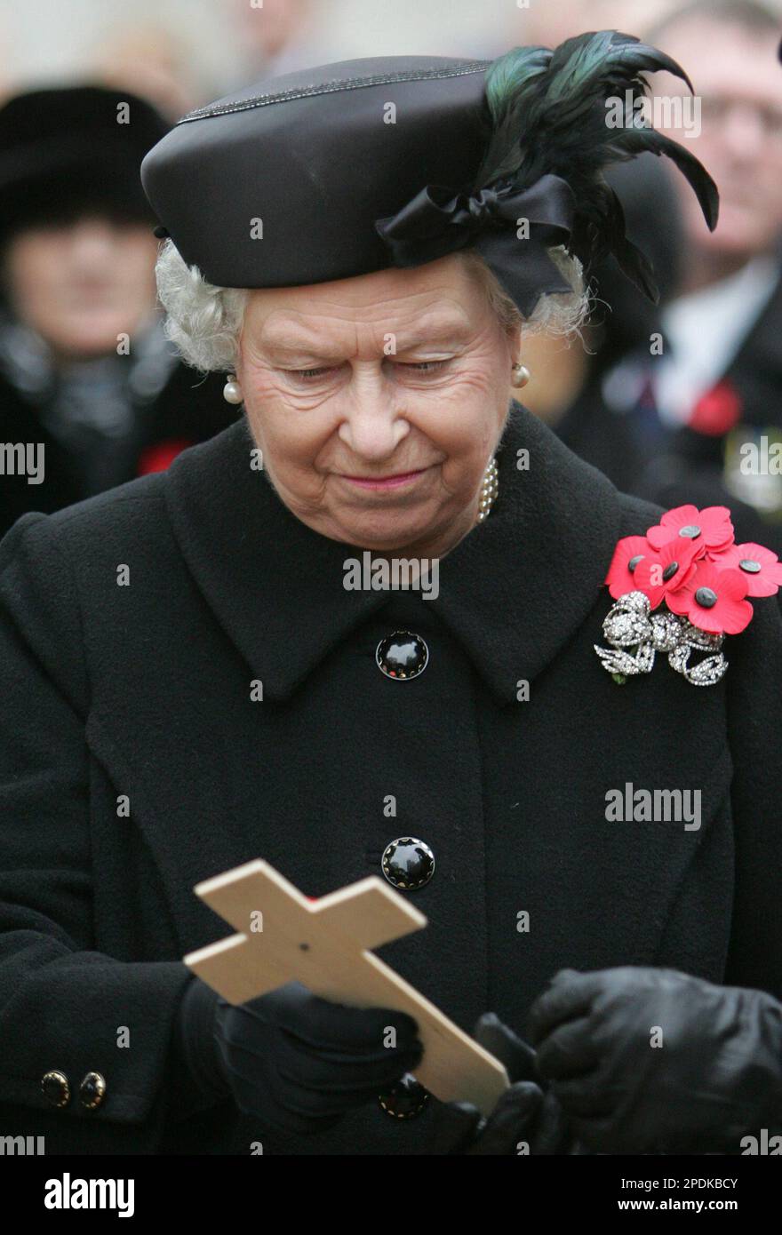Britain's Queen Elizabeth lays a cross as she visits the Field of ...