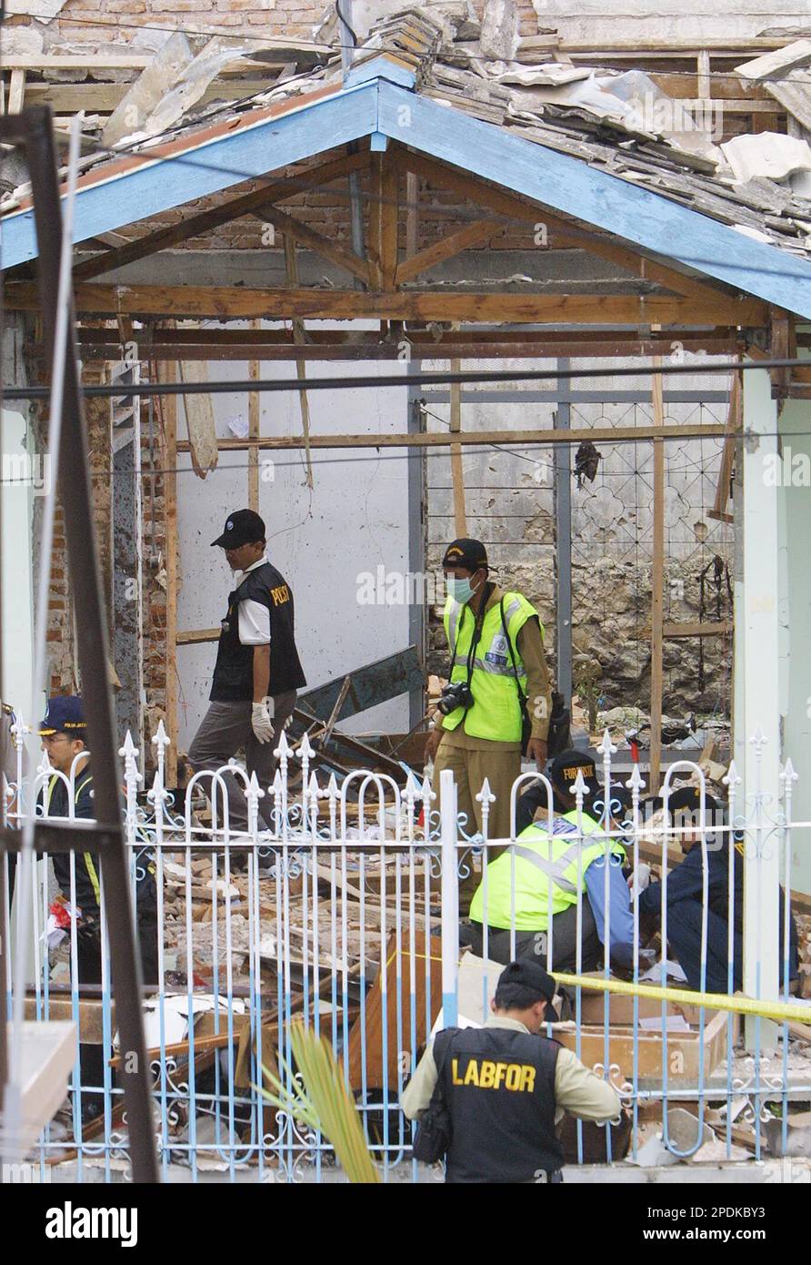 Members of Indonesian Police forensic team investigate the house where ...