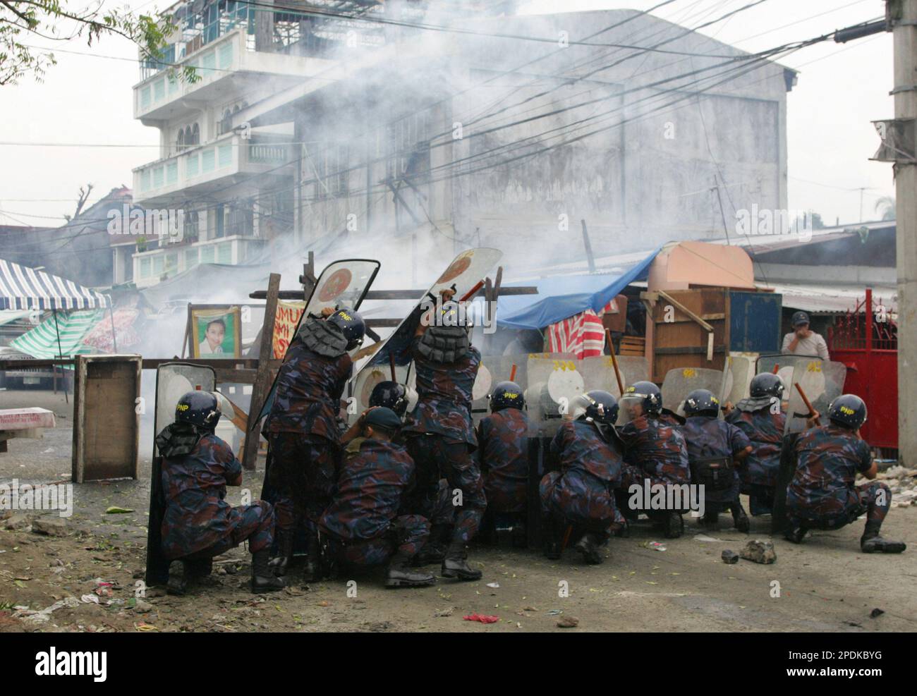 Riot police take their positions as tear gas canisters were fired ...