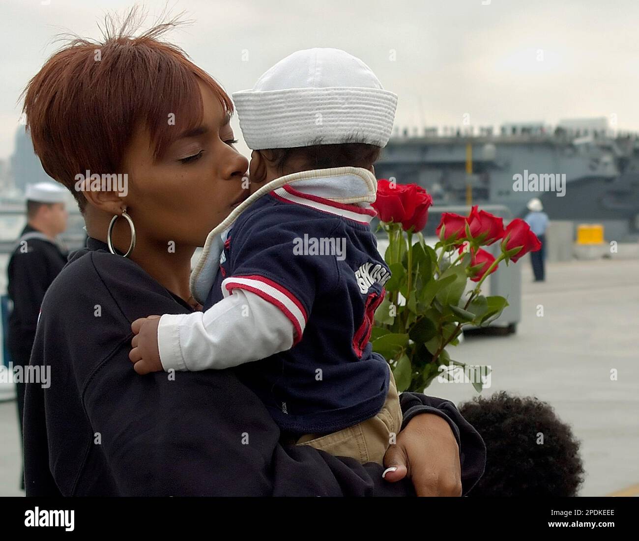 Malika Gavin kisses her son Jason Gavin with the USS Nimitz in the ...