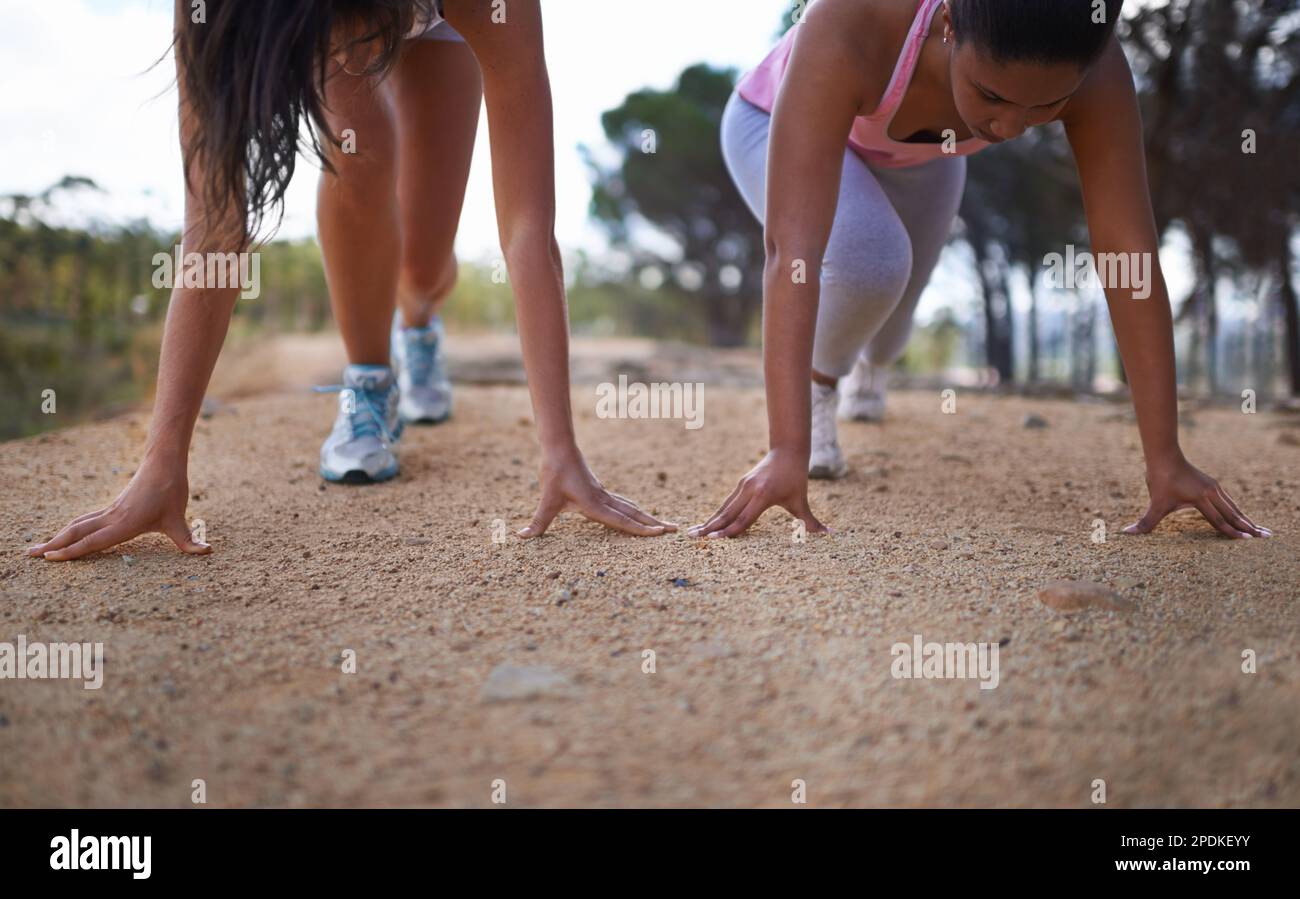 Ready...steady....Two young woman crouched in starting position before a race Stock Photo - Alamy
