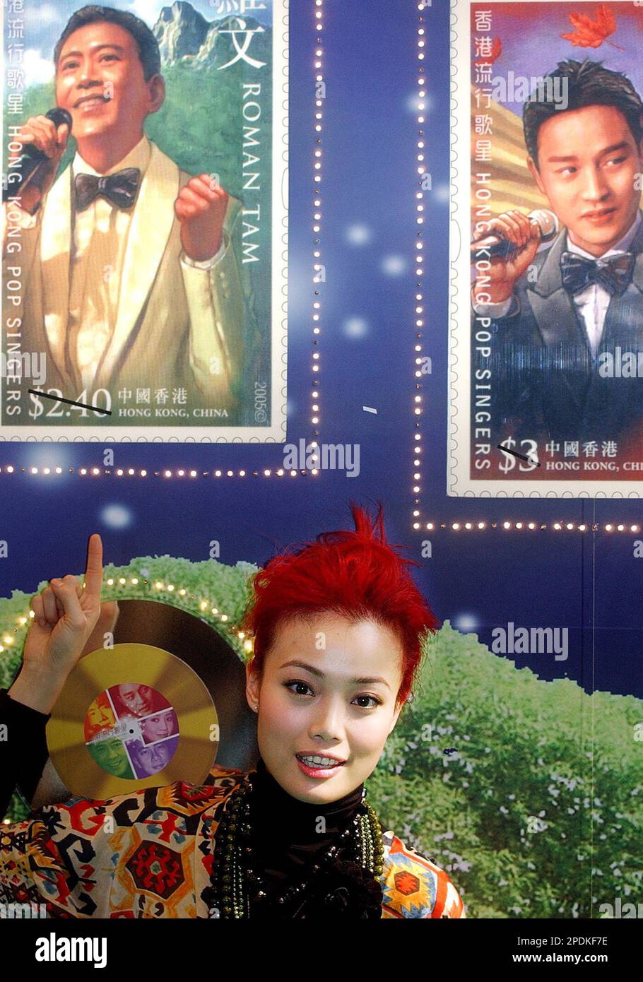 Hong Kong singer Joey Yung poses in front of posters featuring late ...