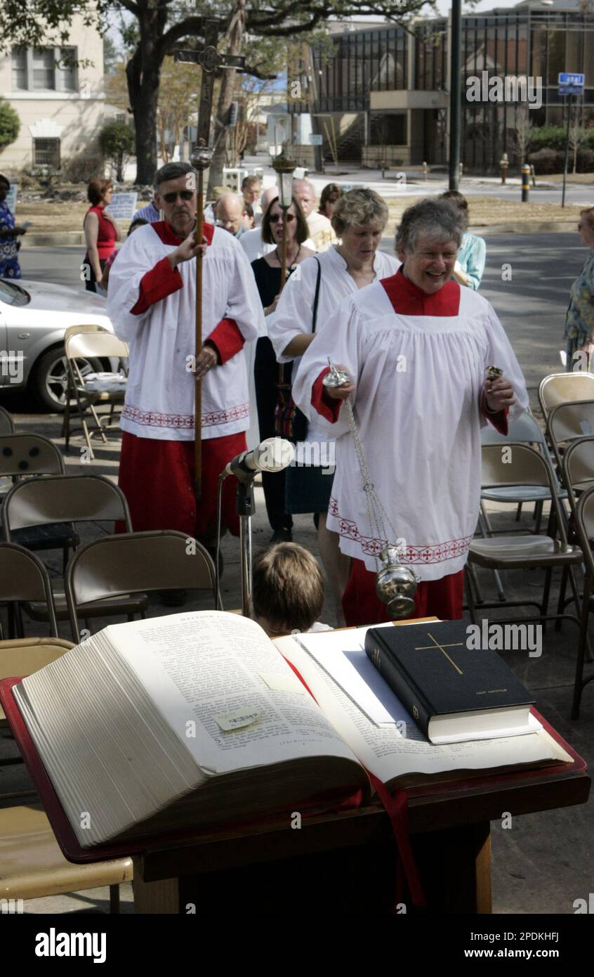 David Kempker leads a processional into the outdoor church services at ...