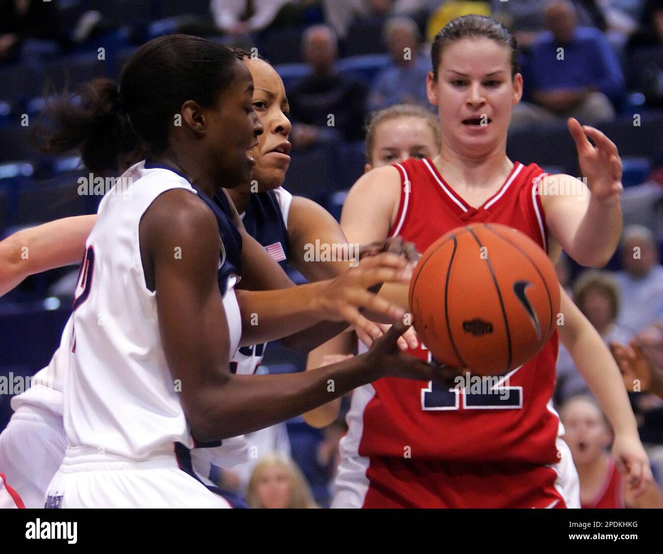 Connecticut's Kalana Brown, left, juggles the ball as Simon Fraser's ...
