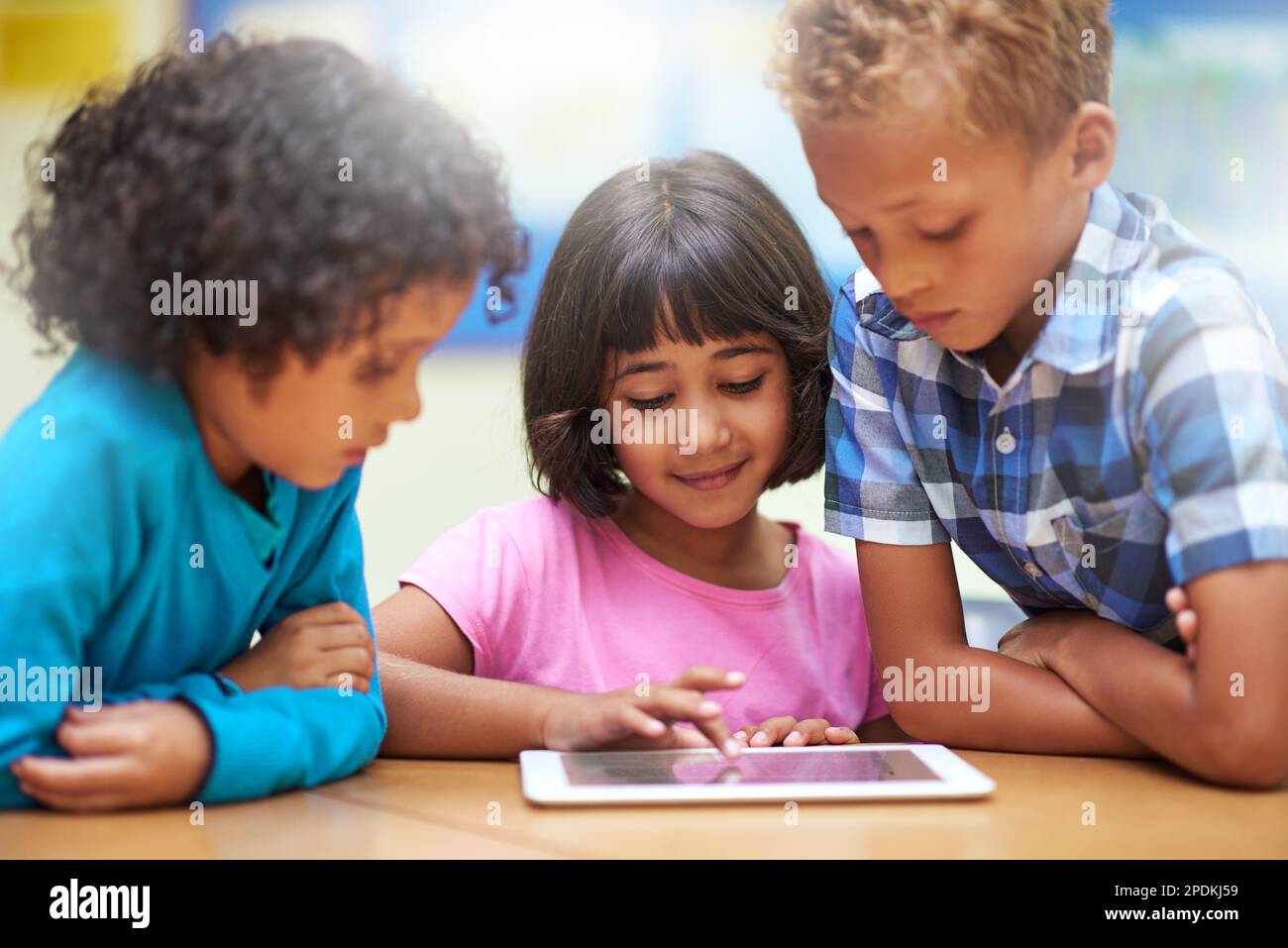 Using their favorite classroom app. elementary school children using a ...