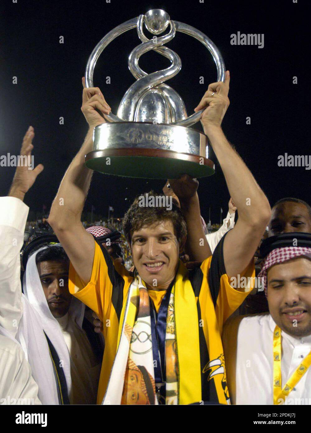 Al Ittihad of Saudi Arabia's Brazilian player Tcheco raises the trophy ...