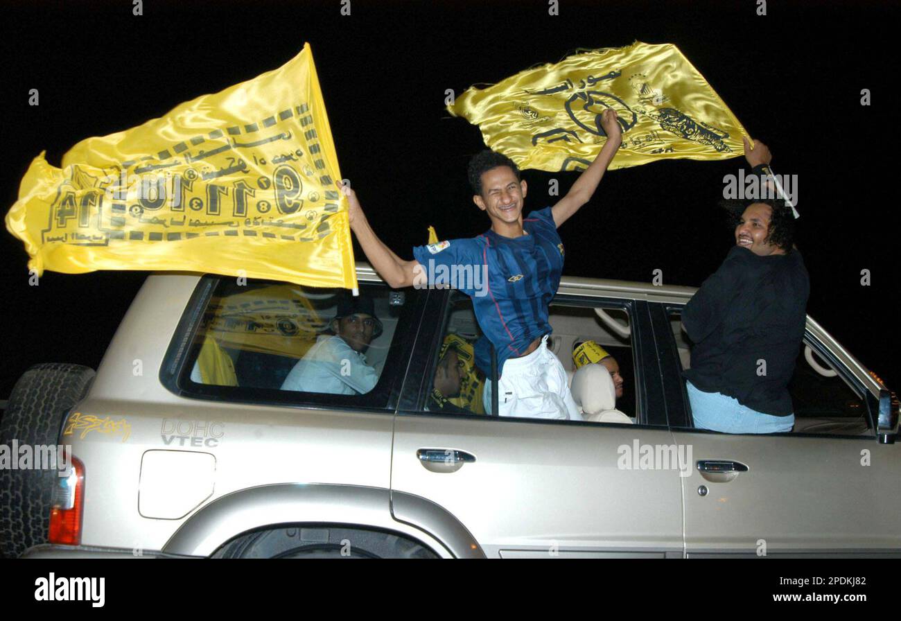 Saudi Al Ittihad fans wave flags as they celebrate after their team won ...