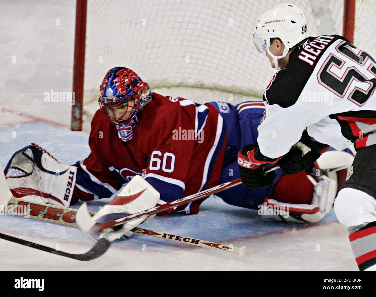 Montreal Canadiens goaltender Jose Theodore, left, makes a save off ...
