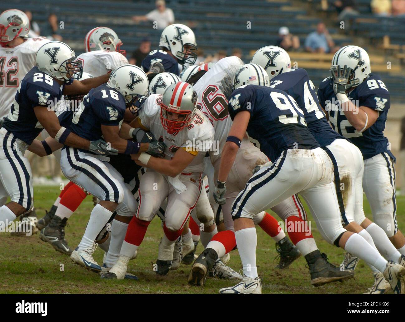 Brown quarterback Joseph DiGiacomo, center, is surrounded by members of ...
