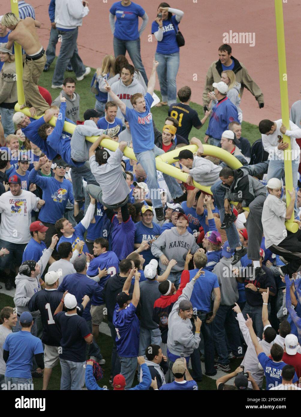 Kansas fans celebrate a 40-15 win over Nebraska by taking down the goal ...