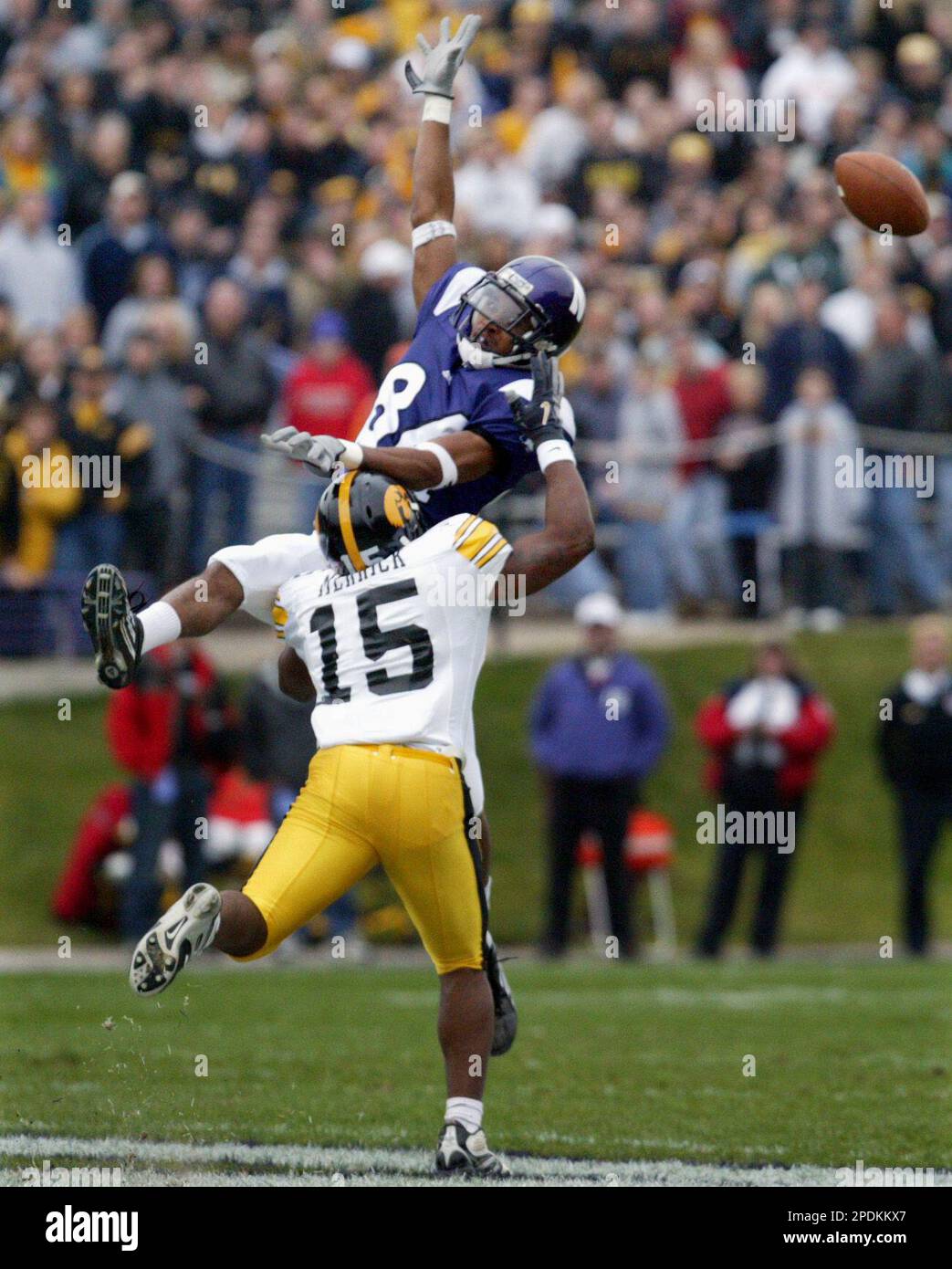 Iowa's Miguel Merrick (15) breaks up a pass play to Northwestern's Kim ...