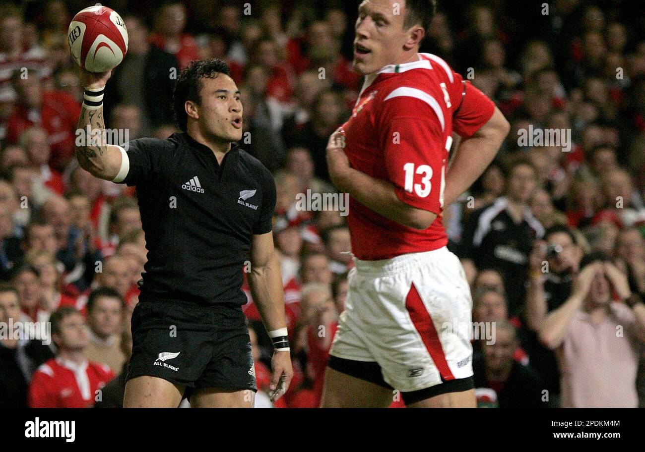 New Zealand's Rico Gear, left, celebrates scoring a try as Wales' Mark ...