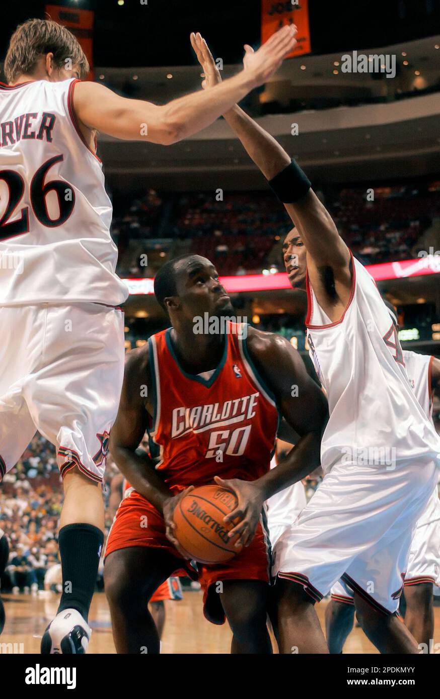 Charlotte Bobcats' Emeka Okafor (50) is guarded by Philadelphia 76ers ...