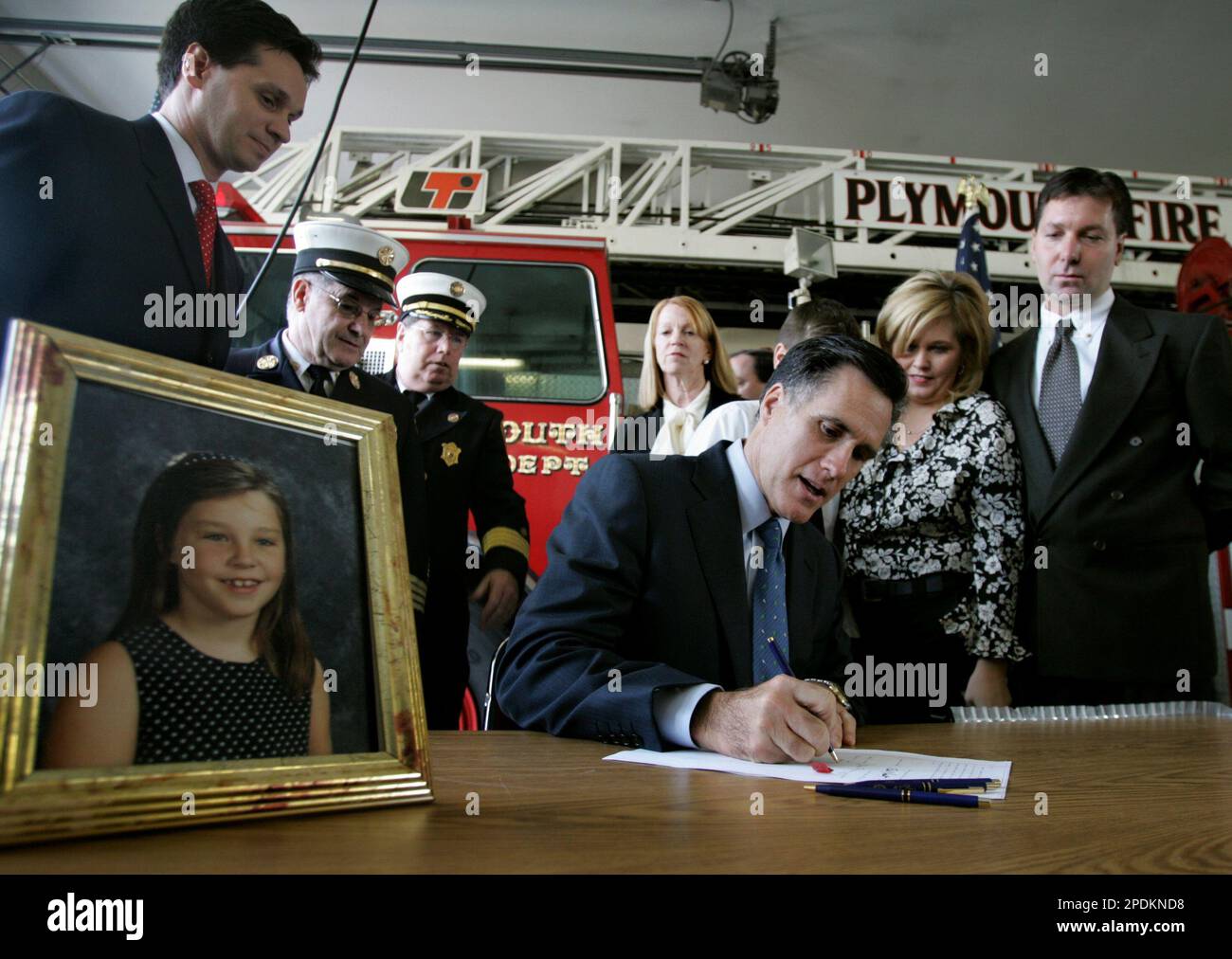 Massachusetts Gov. Mitt Romney, center, signs into law "Nicole's Law ...
