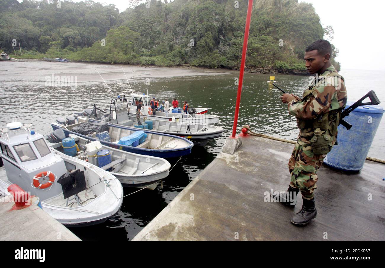 A Colombian marine stand on guard at a Navy base just in Tumaco, in ...
