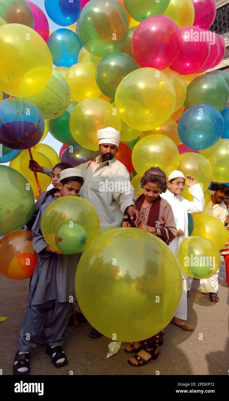 A Pakistani man sells balloons on the occasion of Muslims' festival of ...
