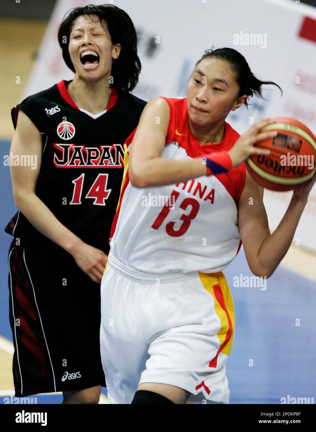 Japan's Maki Eguchi, left, reacts after losing the ball to China's Liu ...