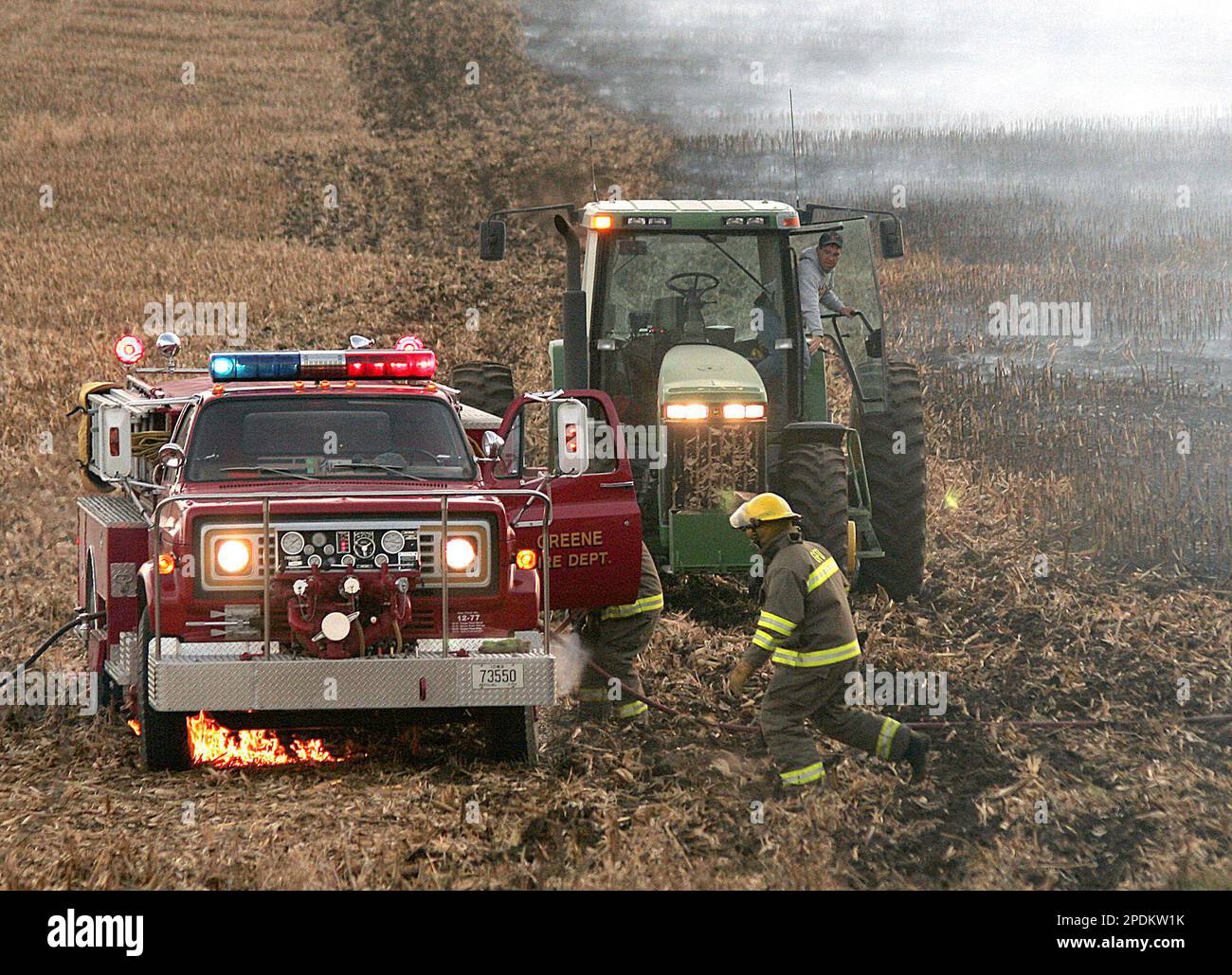 Firefighters from the Greene Fire Department scramble to extinguish a ...
