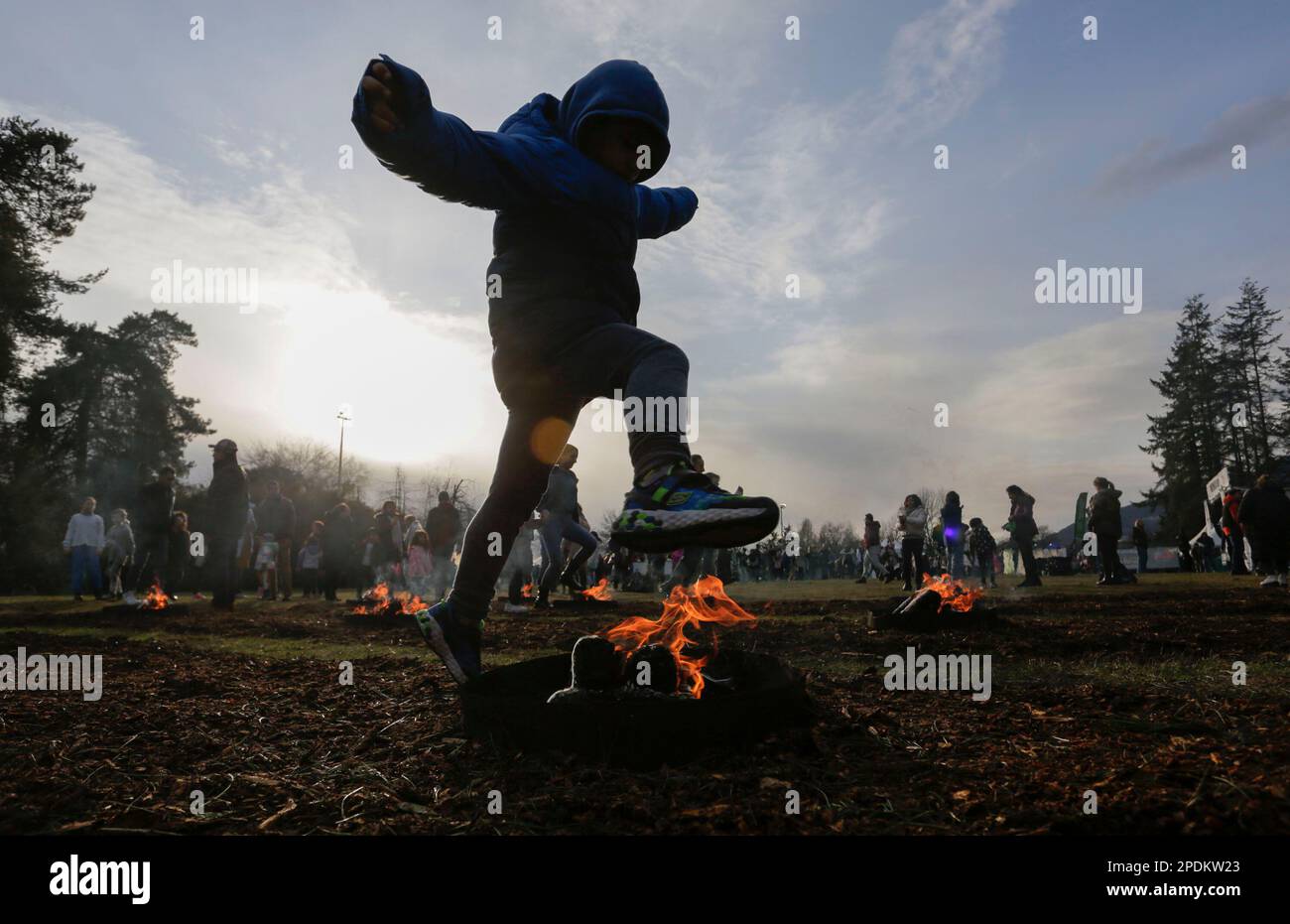 Vancouver, Canada. 14th Mar, 2023. A child leaps over a bonfire during ...