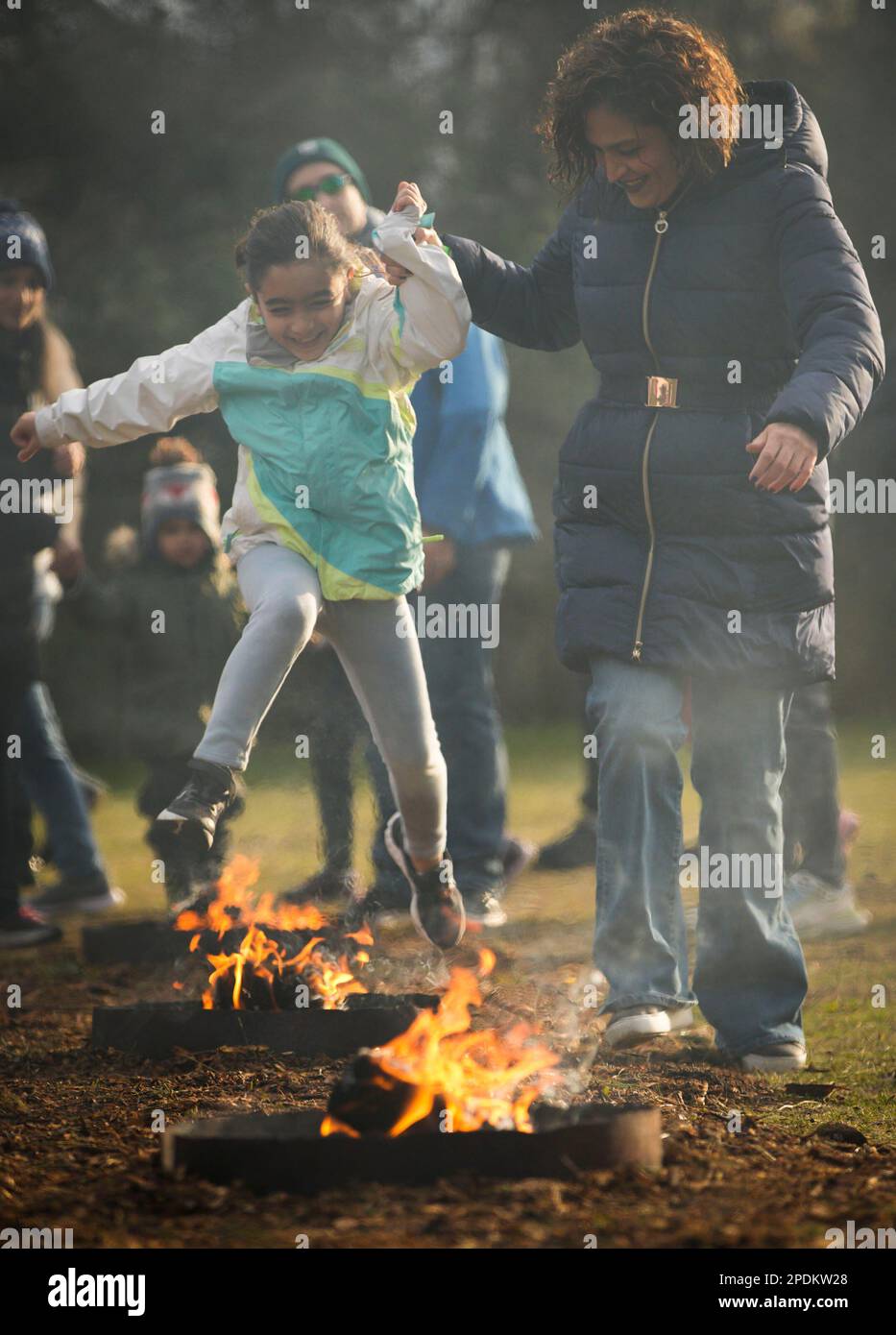 Vancouver, Canada. 14th Mar, 2023. A woman helps a girl leap over a ...