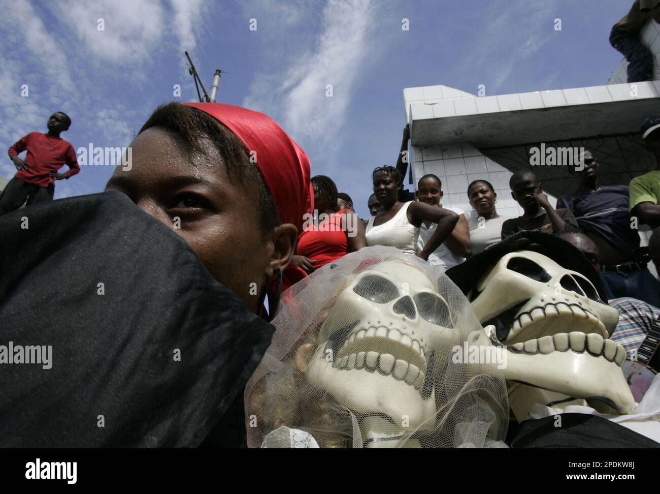 A Voodoo believer holds two skull puppet during the Voodoo holiday ...