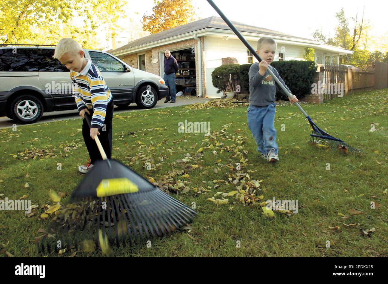 Ray Hart, center, background, watches as his grandsons Ryan, left, and ...