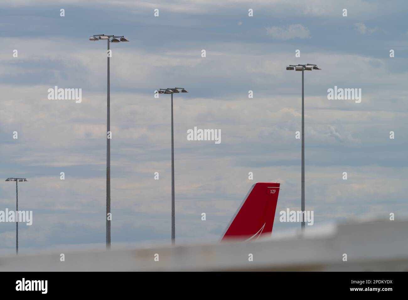 International airport outside view showing aeroplane tail fin, clouds ...