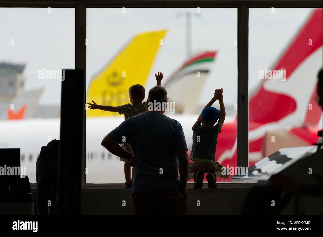 Children looking through the window while waiting at airport, Sydney ...