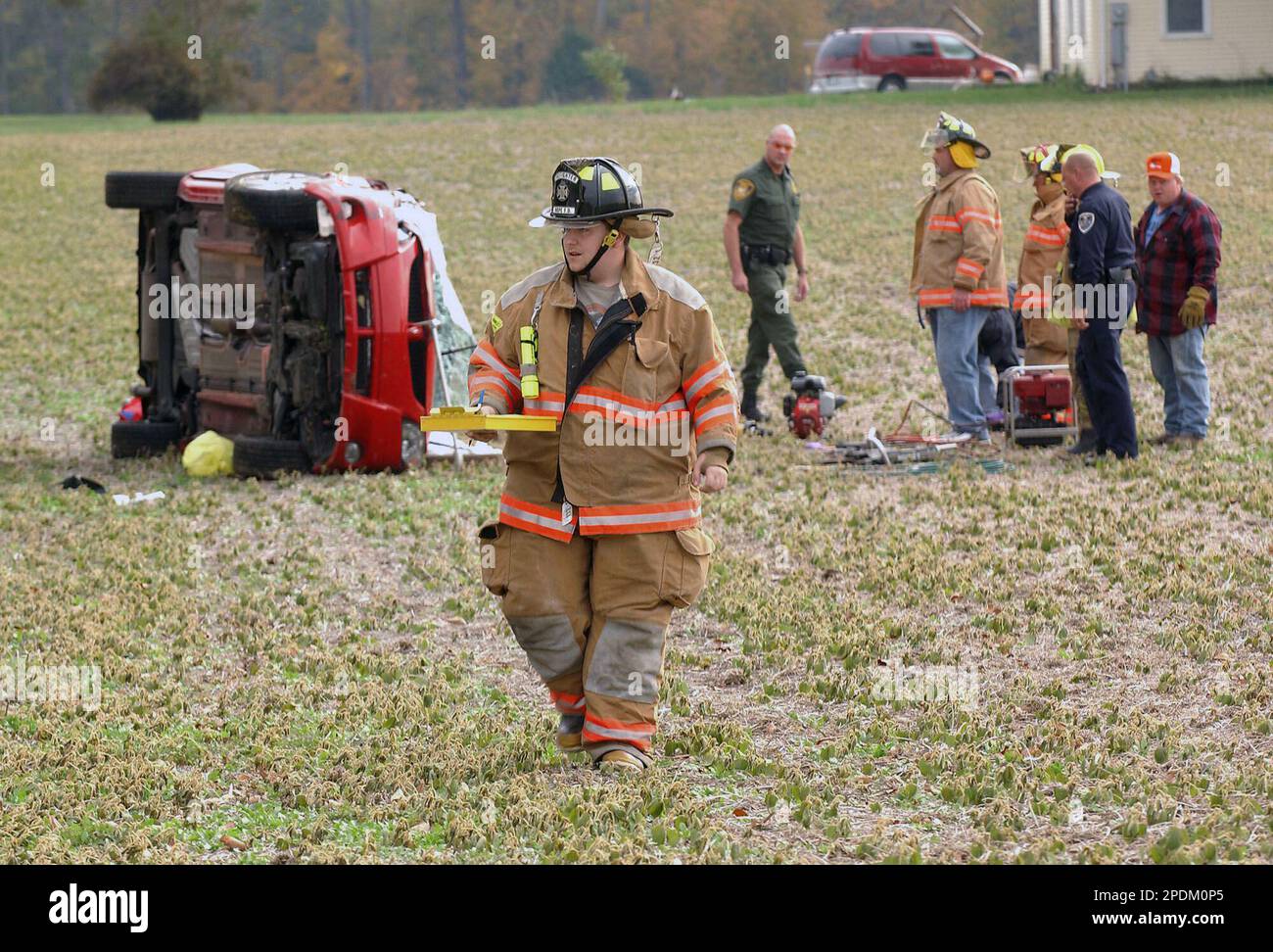 Firefighter Justin Mathis walks from the scene of a fatal wreck near ...