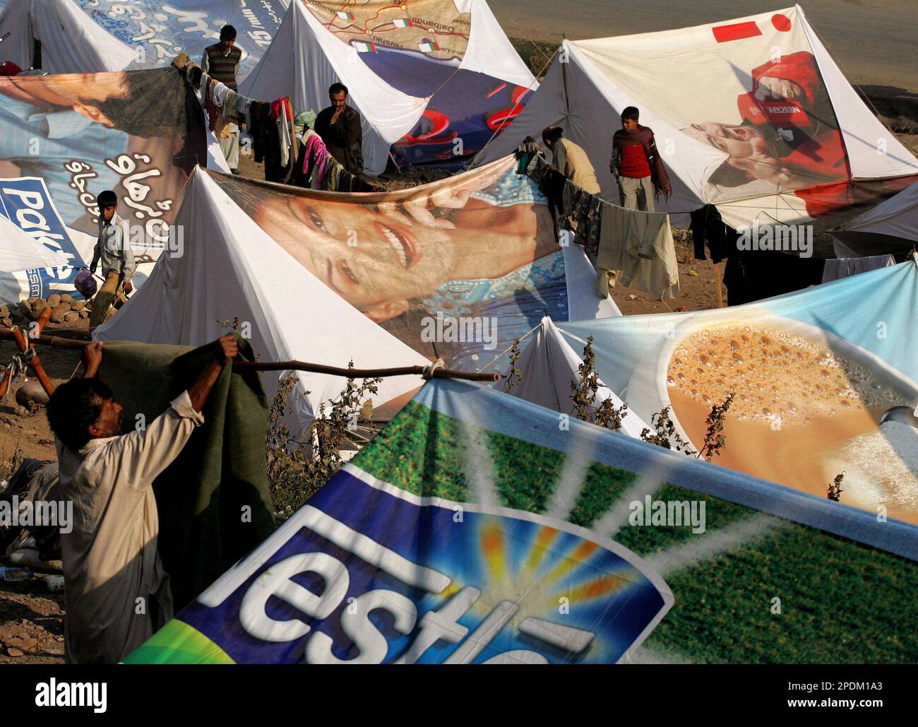 Pakistani refugees, left homeless after the Oct. 8 earthquake, set up a ...
