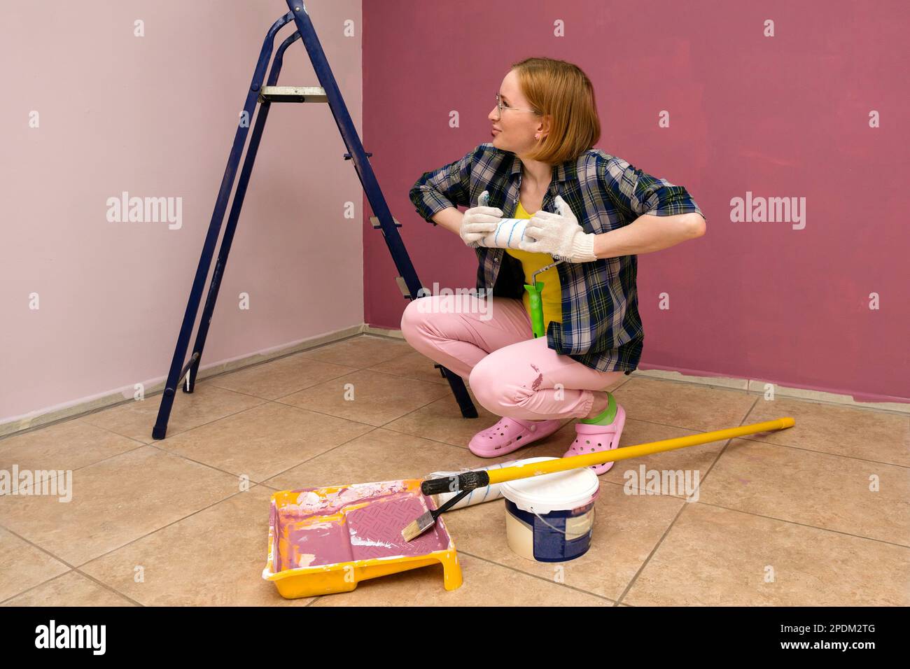 Strong woman professional house painter paint walls. Female worker ...
