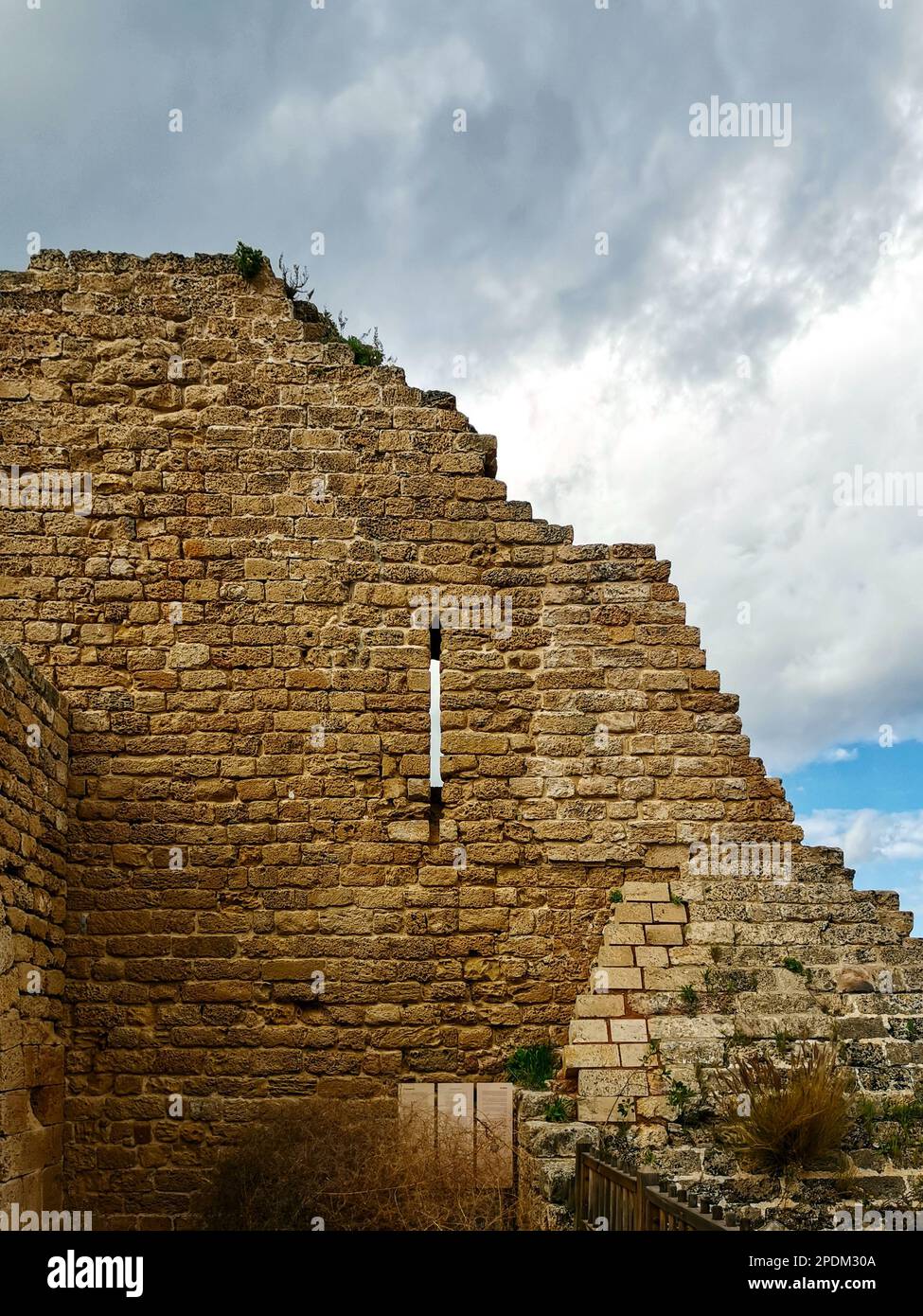 Ancient broken sandstone brick wall. Ruins of ancient city Caesarea ...