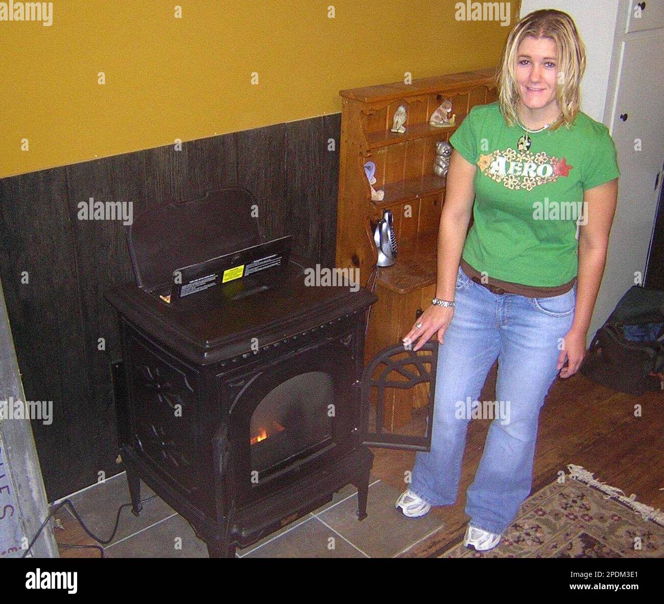 Andrea Marsh stands next to a corn-burning stove at RAM Stoves and ...