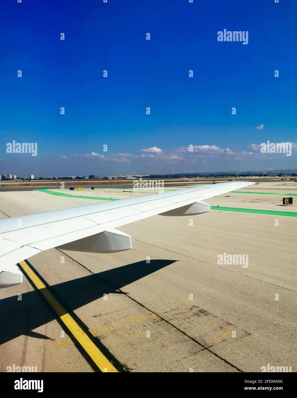 View from porthole. Plane moving along runway and getting ready for ...