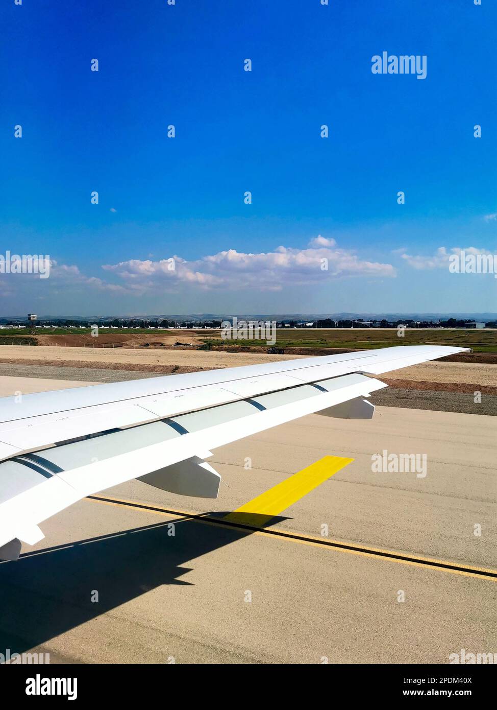 View from porthole. Plane moving along runway and getting ready for ...
